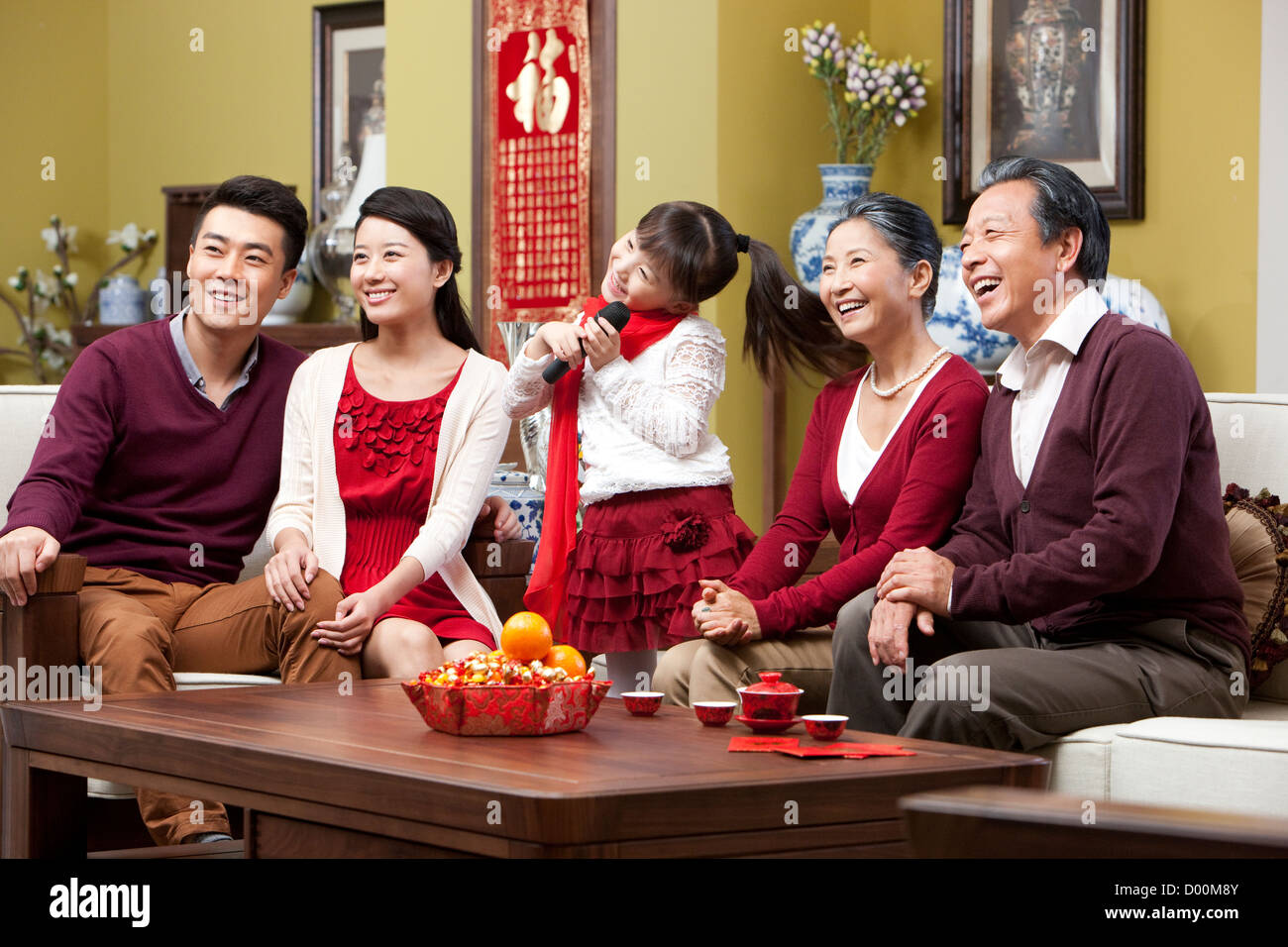 Happy family singing karaoke during Chinese New Year Stock Photo - Alamy