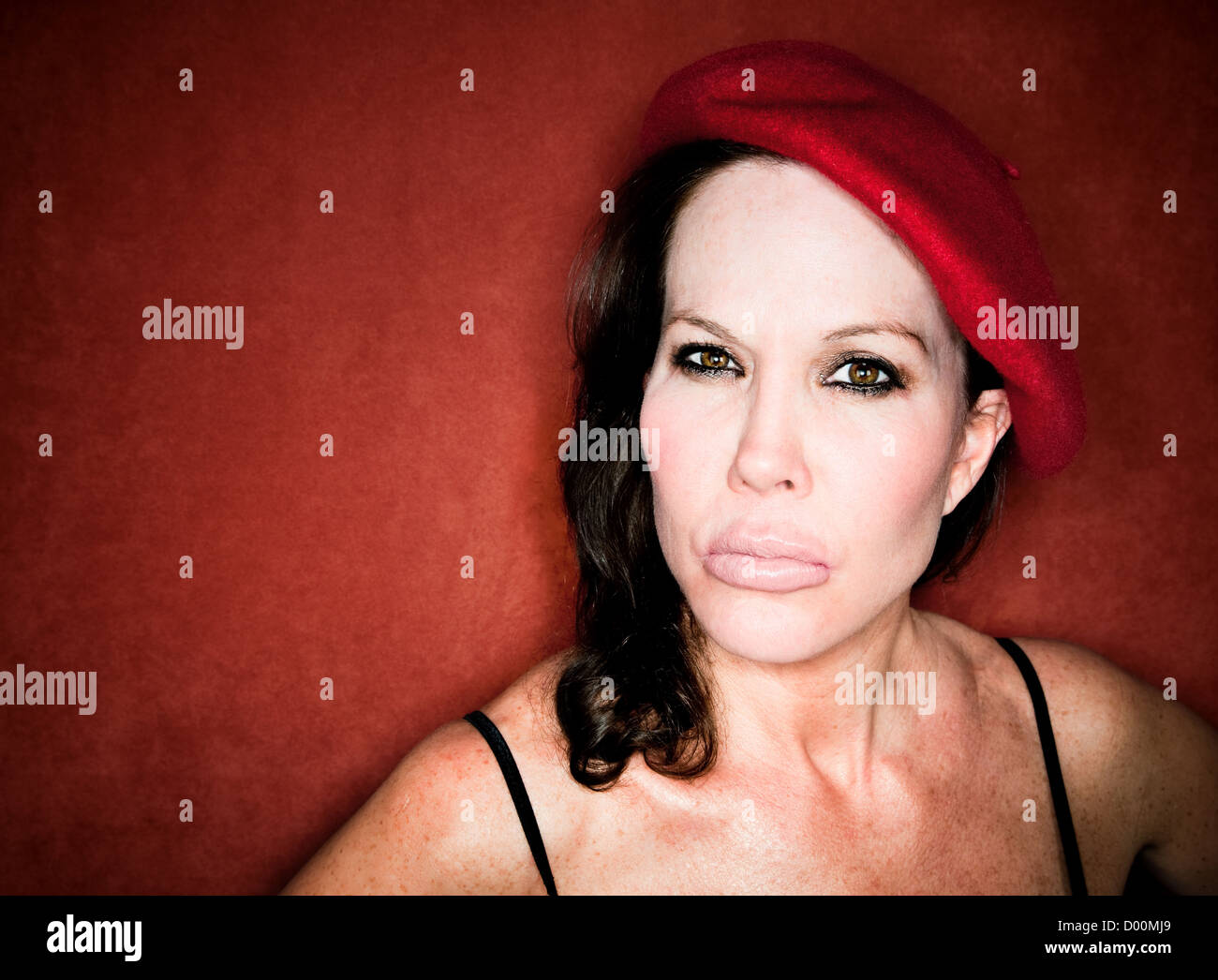 Pretty woman wearing a bright red beret Stock Photo - Alamy