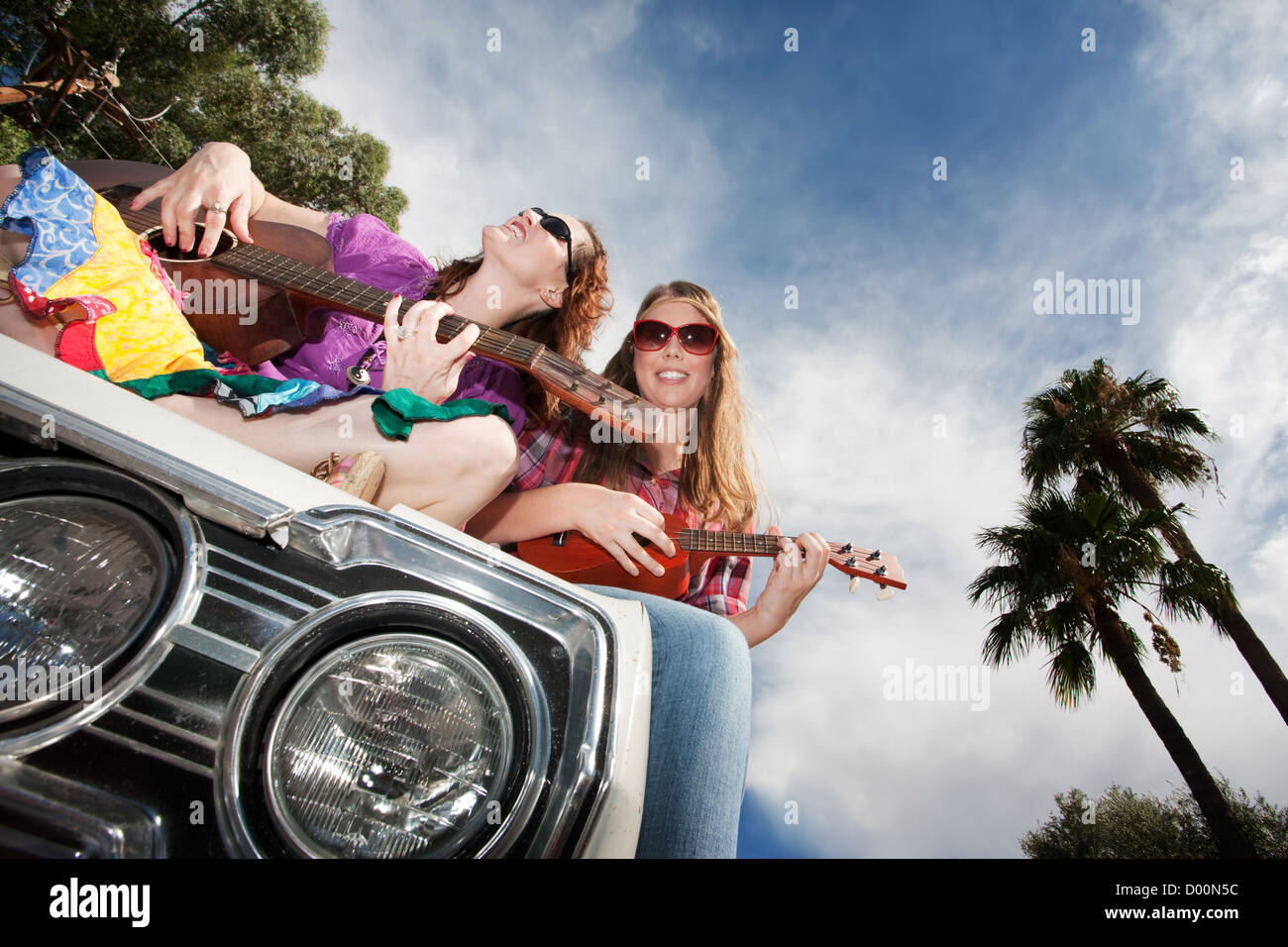 Female Musicians on an Old Car Stock Photo - Alamy