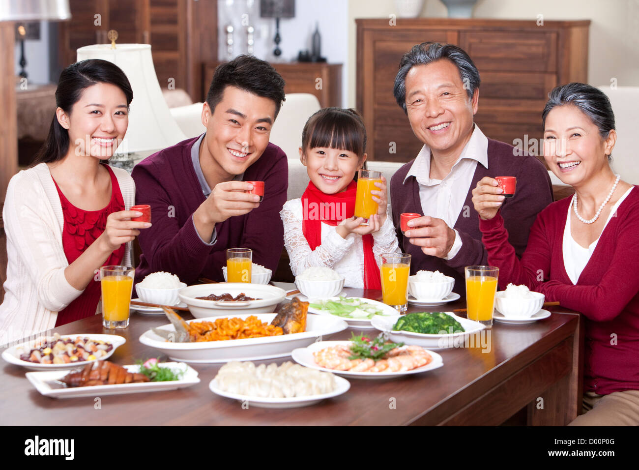 Family toasting at dinner table during Chinese New Year Stock Photo - Alamy