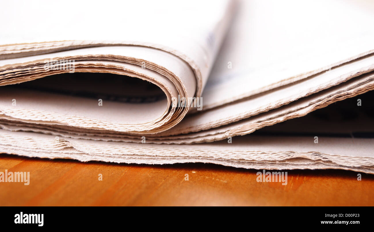 stack of newspaper on desktop showing news concept Stock Photo - Alamy