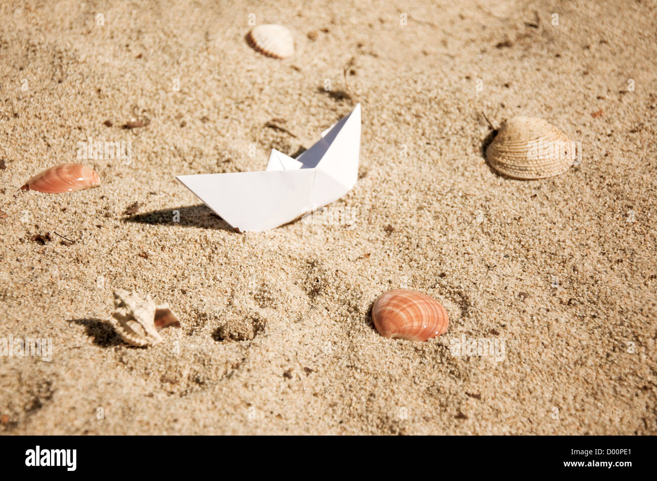 paper boat sailing on blue water surface Stock Photo - Alamy