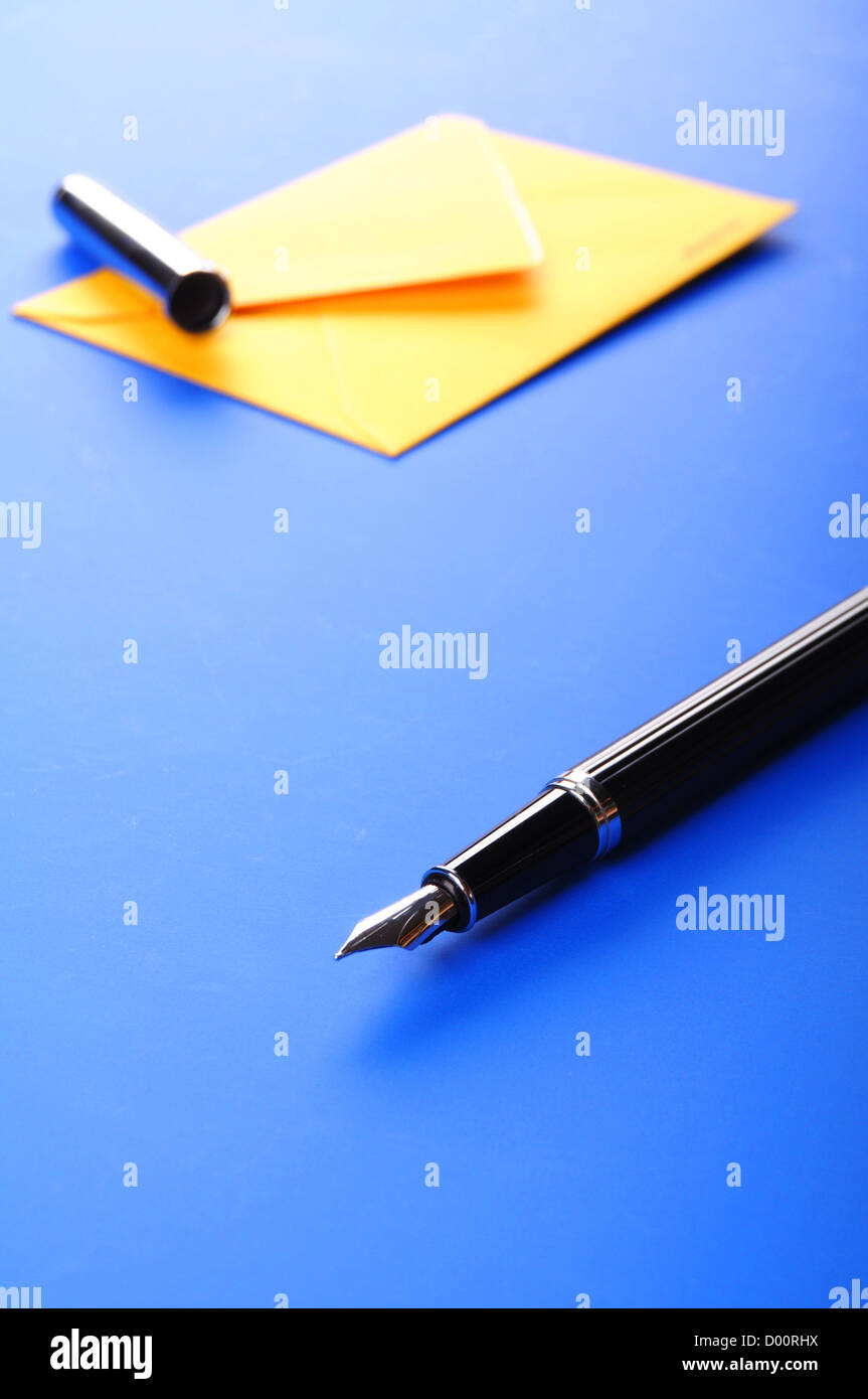 mail or email concept with envelope and pen Stock Photo - Alamy