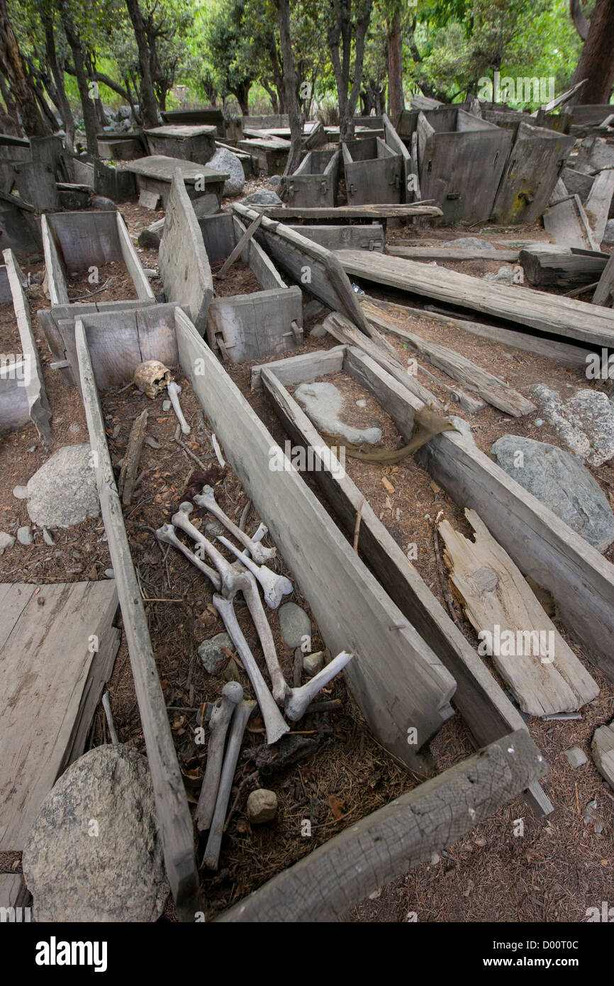Open graves and human bones on the surface of the graveyard, Krakl Village, Bumburet Valley ...