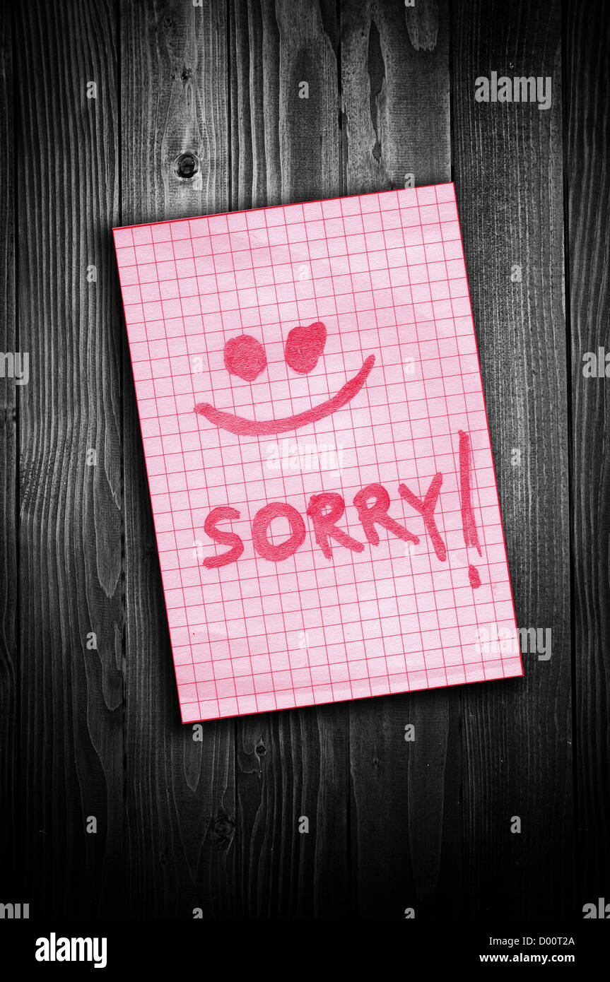 Sorry, handwritten reminder paper note over a wooden background Stock ...