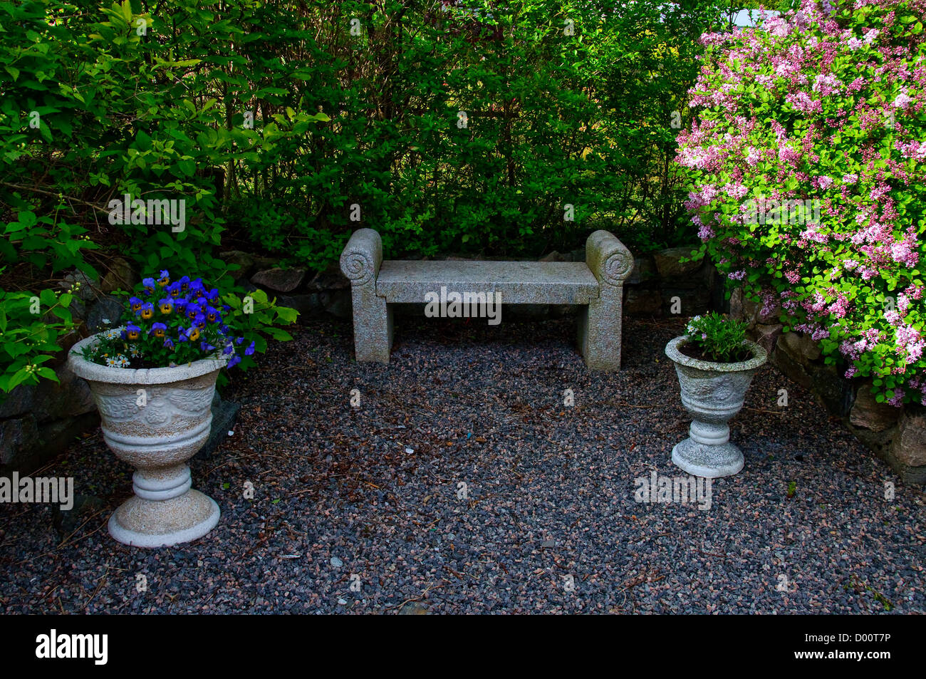 A stone bench hidden in a park Stock Photo - Alamy