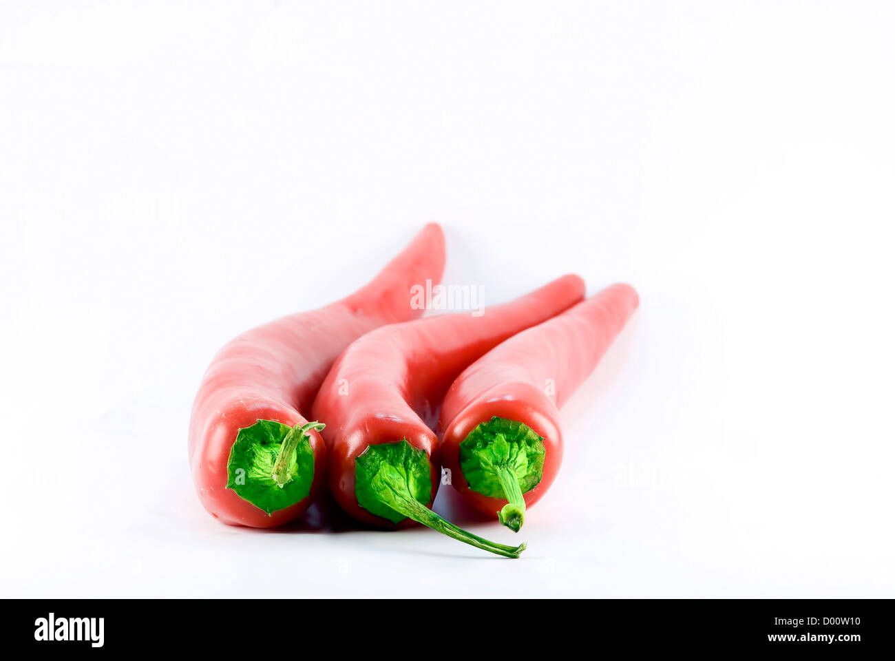 three red chili on white background Stock Photo - Alamy