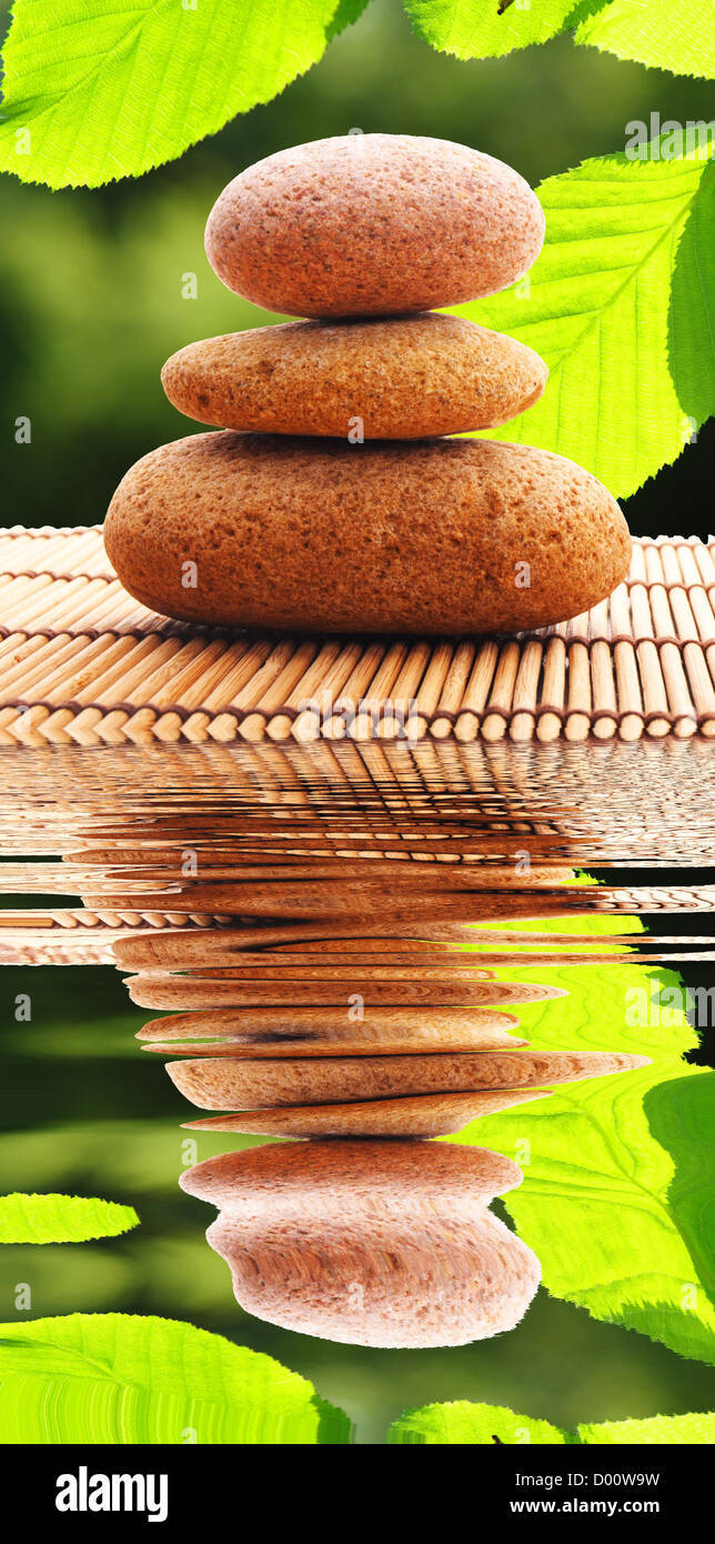 zen stones and water reflection showing spa concept Stock Photo - Alamy