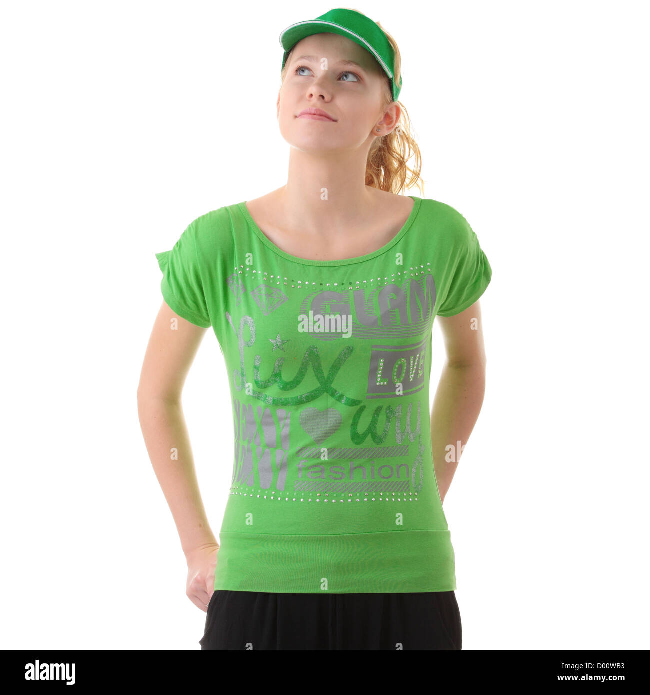 Young beautiful blond woman with green cap looking up isolated on white ...