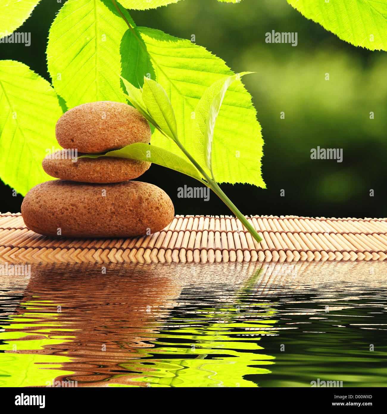 zen stones and water reflection showing spa concept Stock Photo - Alamy