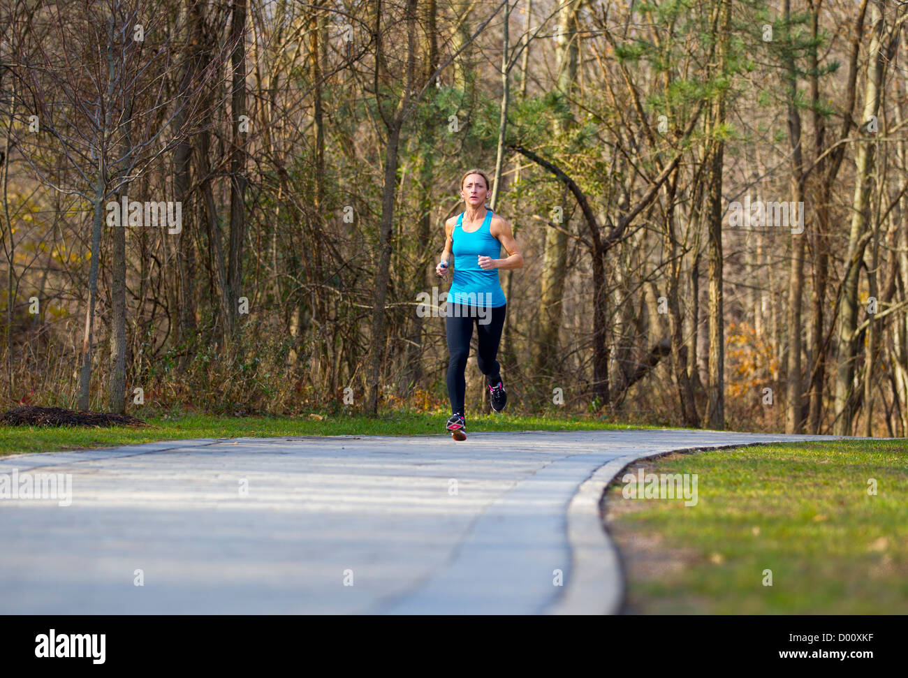 Fit woman jogging on a path Stock Photo - Alamy