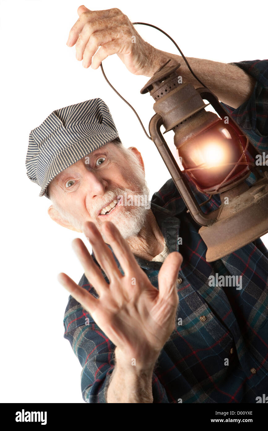 Apprehensive railroad man holding a glowing red lantern Stock Photo - Alamy