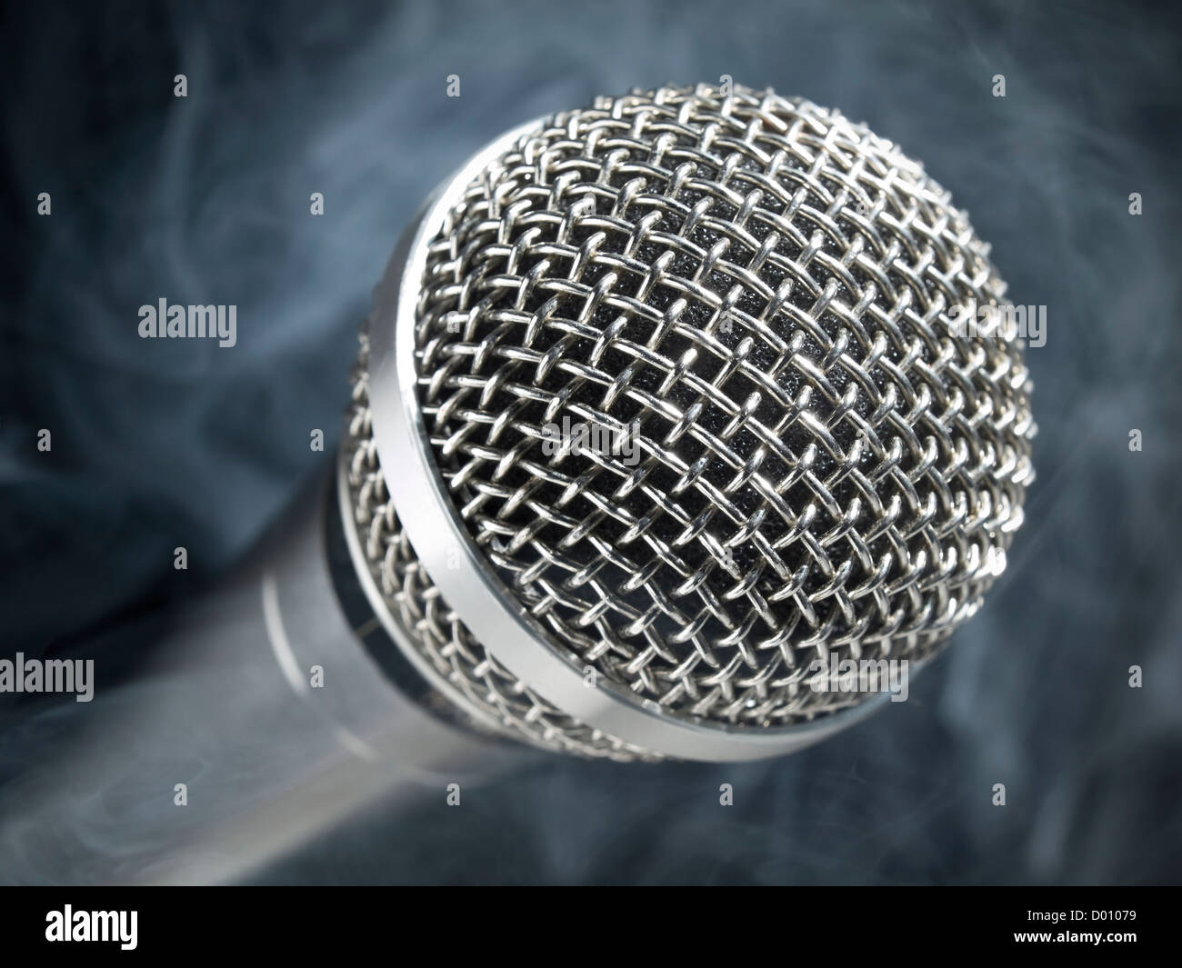 A dynamic microphone over a black and smoky background Stock Photo - Alamy