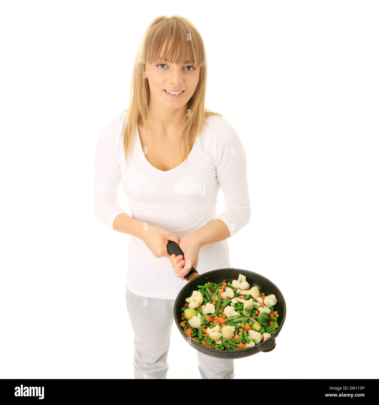 Image of a young woman cooking healthy food in the kitchen Stock Photo ...
