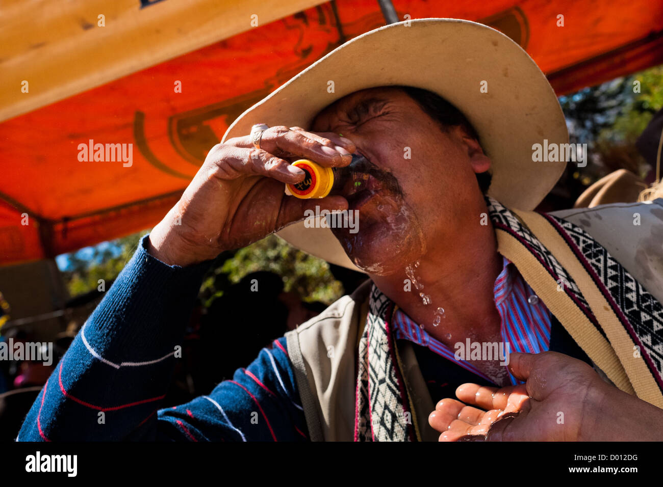A Peruvian peasant drinks liquor during the Yawar Fiesta held in the ...