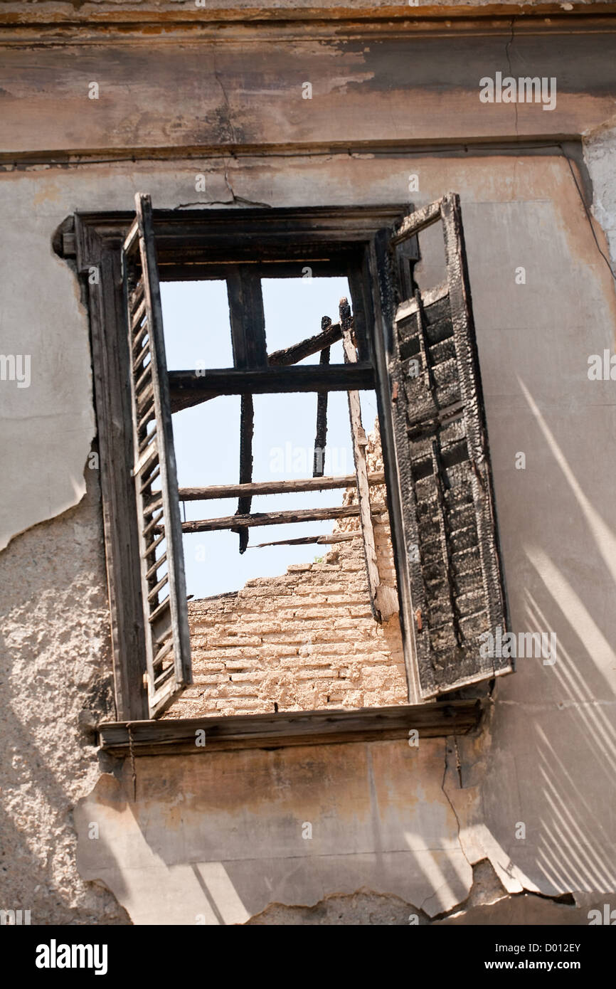 window with black burned shutters after fire Stock Photo - Alamy