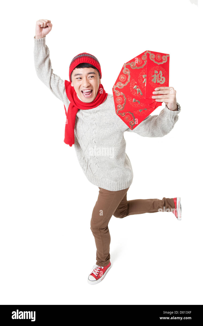 Cheerful young man celebrating Chinese New Year with red envelops Stock ...