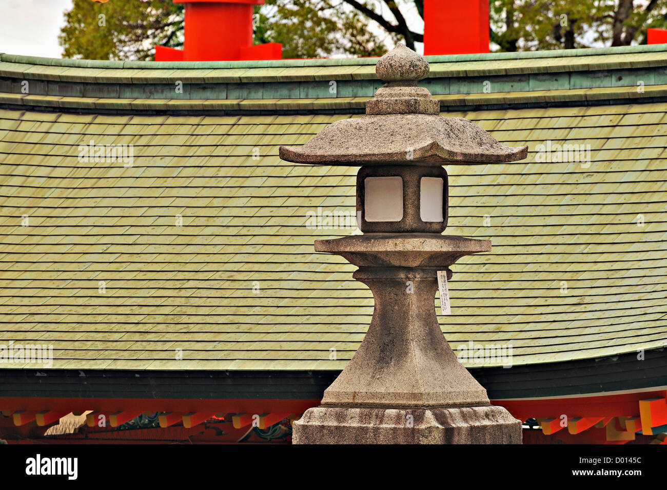 Tiled pavillion roof and stone lantern at Fushimi Inari Taisha shrine ...