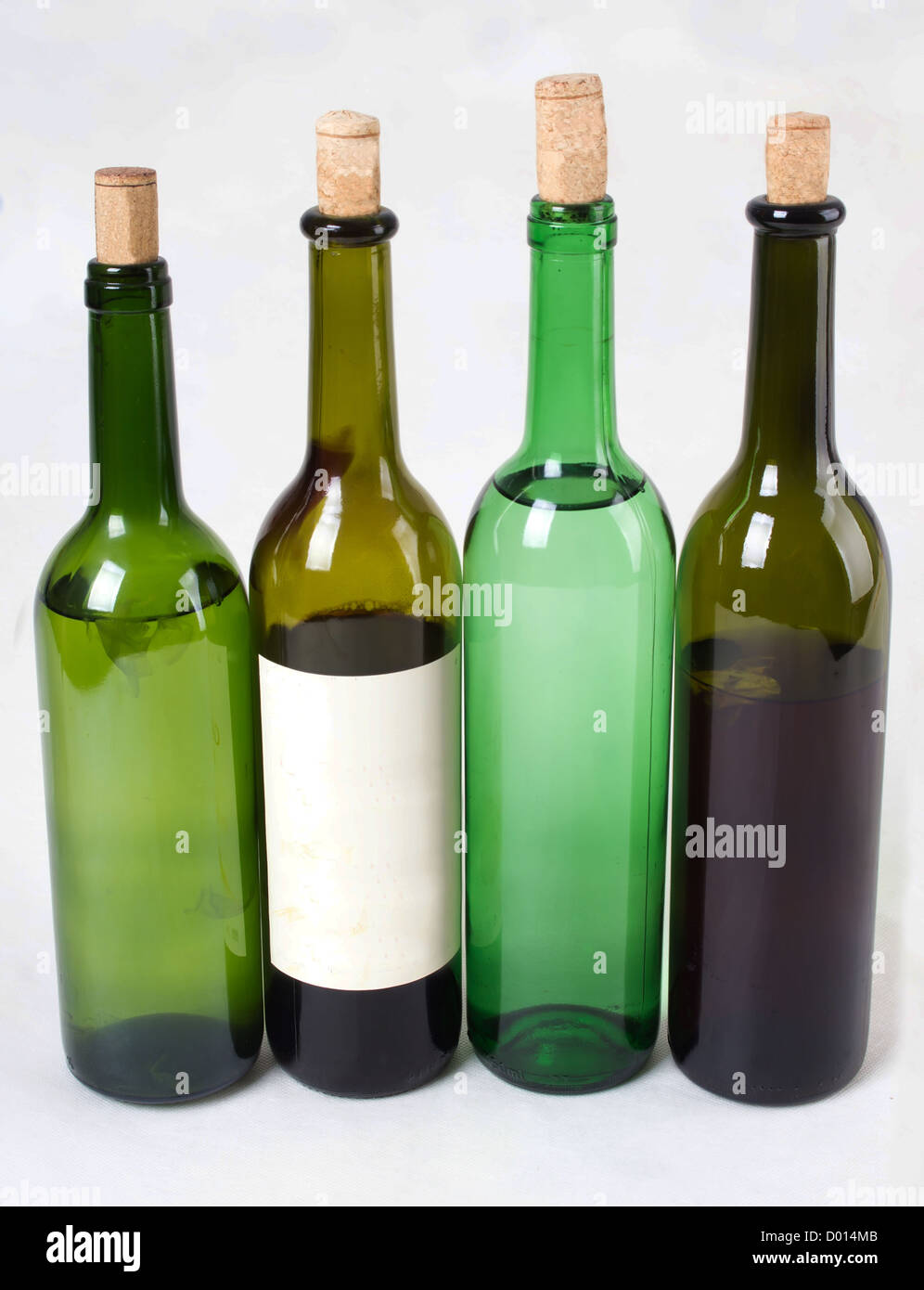 Four wine bottles isolated on white background Stock Photo - Alamy