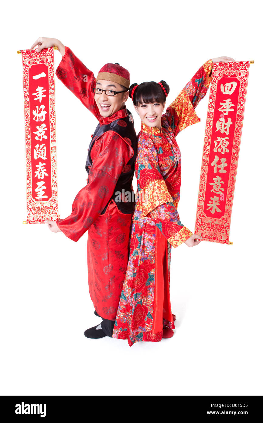 Cheerful couple in traditional Chinese clothing showing Chinese ...