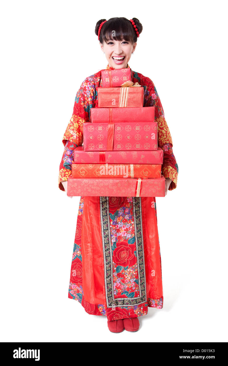 Joyful young woman in traditional Chinese clothing holding gift boxes ...