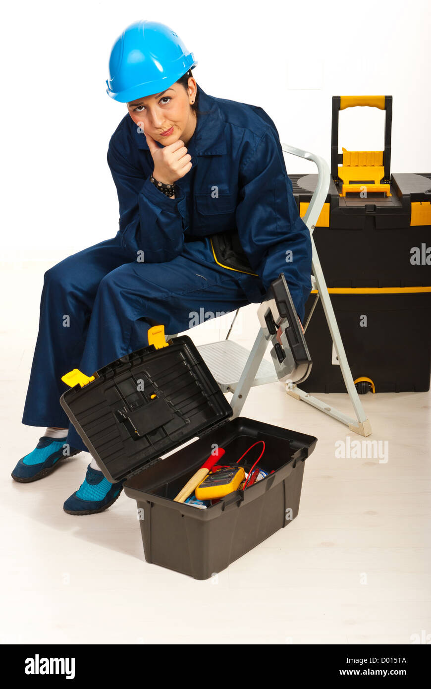 Confused workers woman sitting on step ladder with tool box open Stock ...