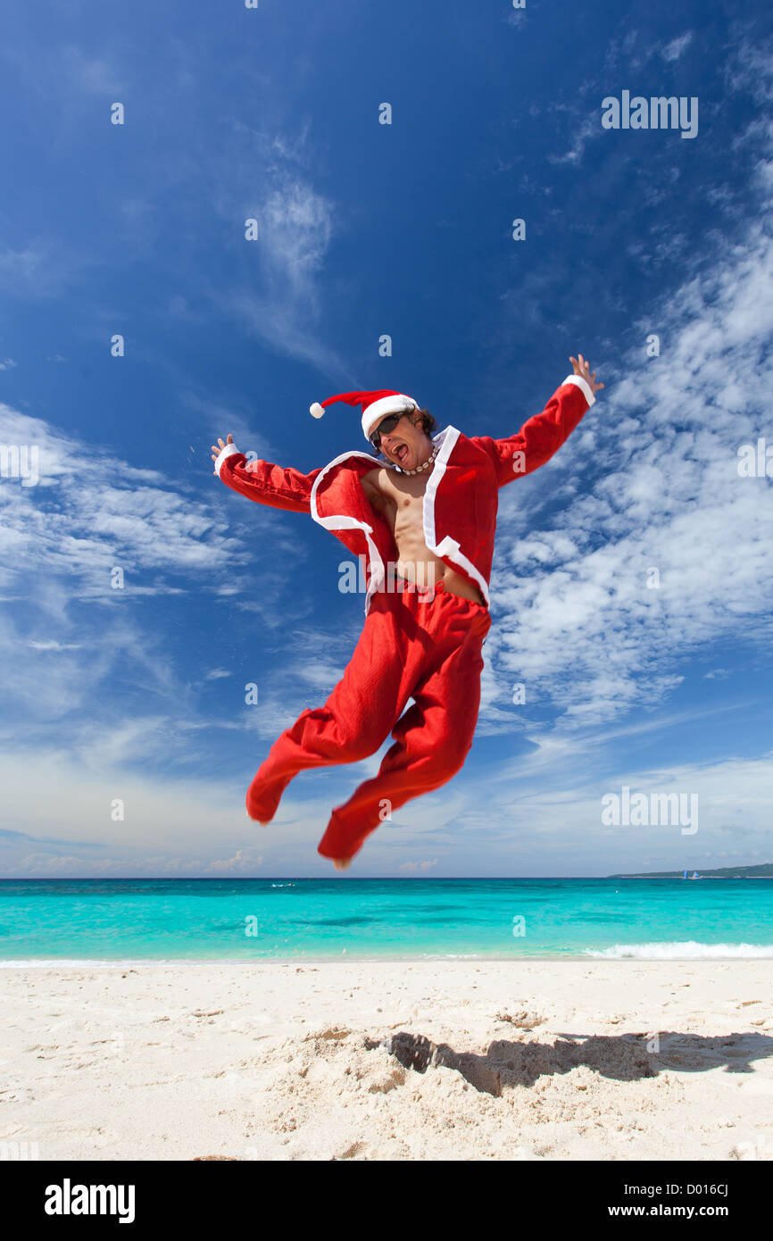 Santa Claus jumping on tropical beach Stock Photo - Alamy