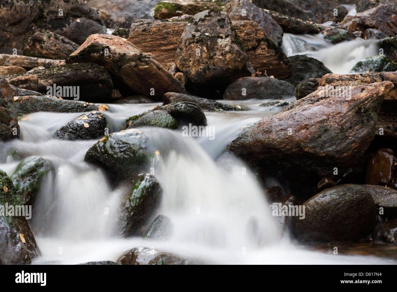Flowing river water over rocks Stock Photo - Alamy