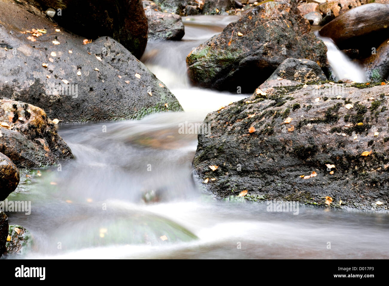 Flowing river water over rocks Stock Photo - Alamy