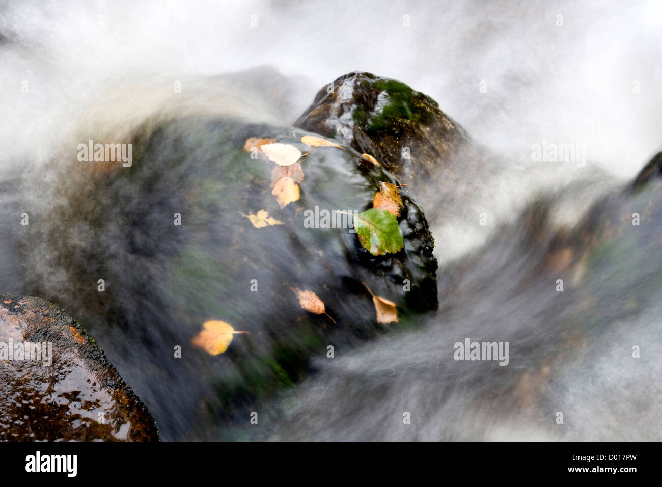 Flowing river water over rocks Stock Photo - Alamy