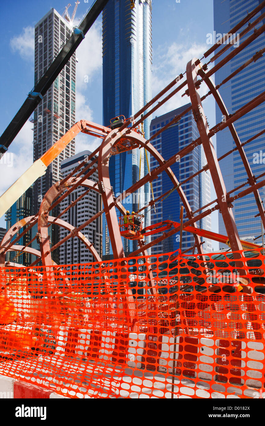 Cherry-pickers are used to hoist the man into position safely in order ...