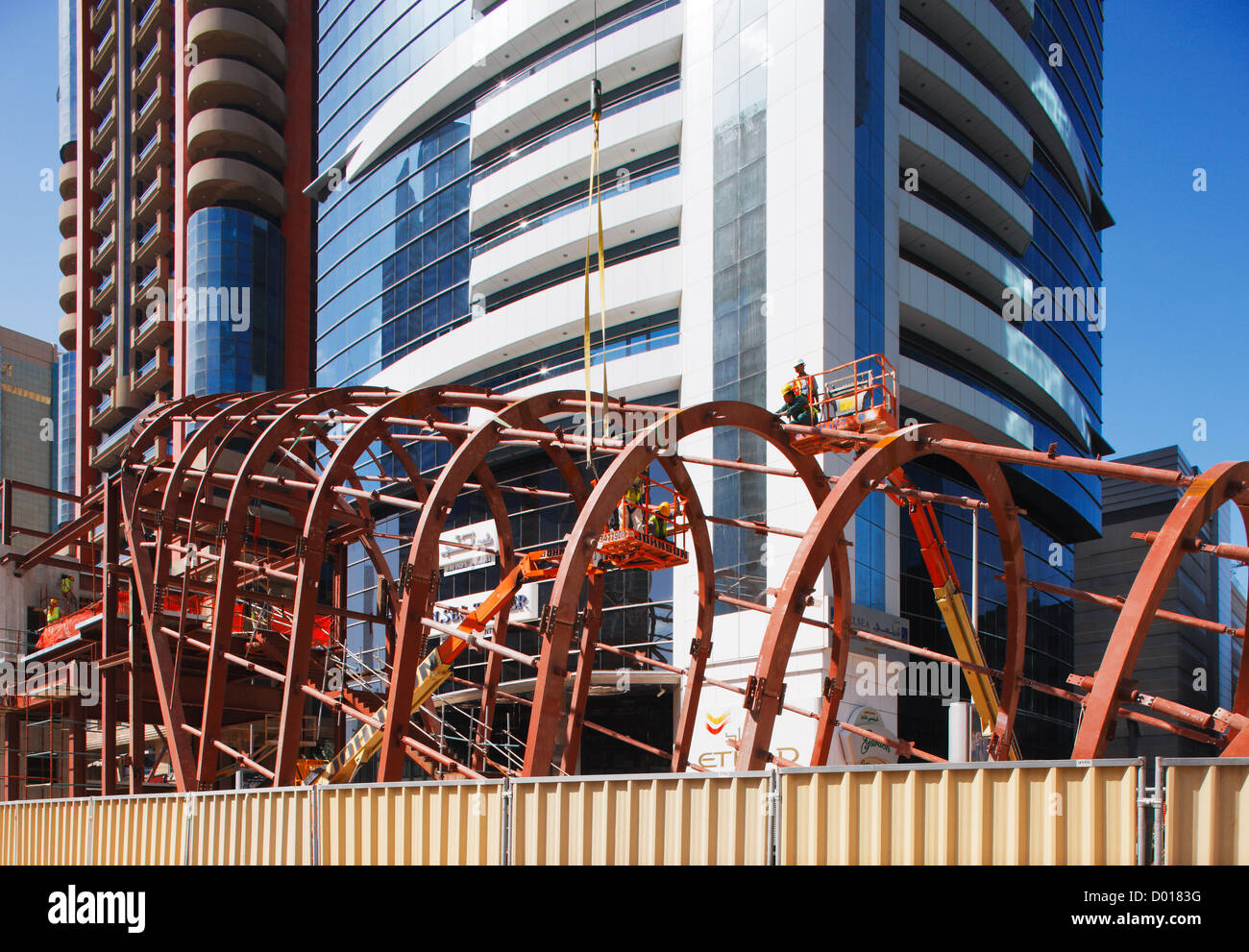 Cherry-pickers are used to hoist the man into position safely in order ...