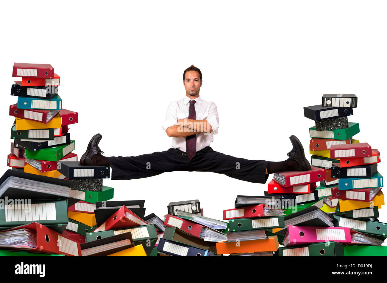 Businessman doing splits over stack of files Stock Photo - Alamy