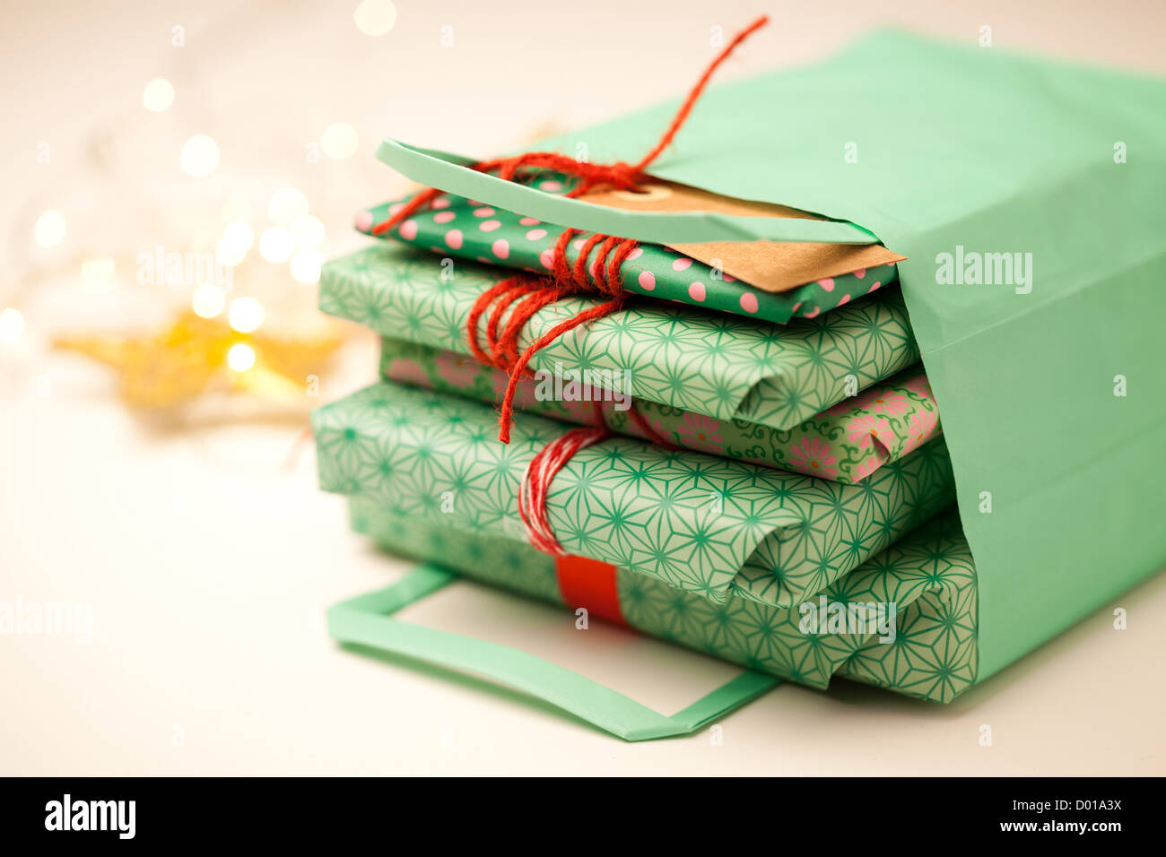 Close up of stack of gifts in bag with decorations in background Stock ...