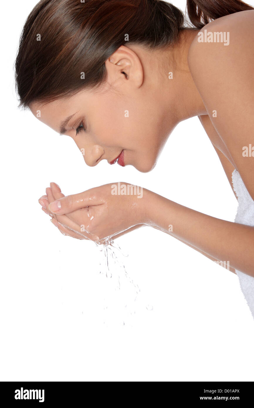 Young beautiful female washing her face Stock Photo - Alamy