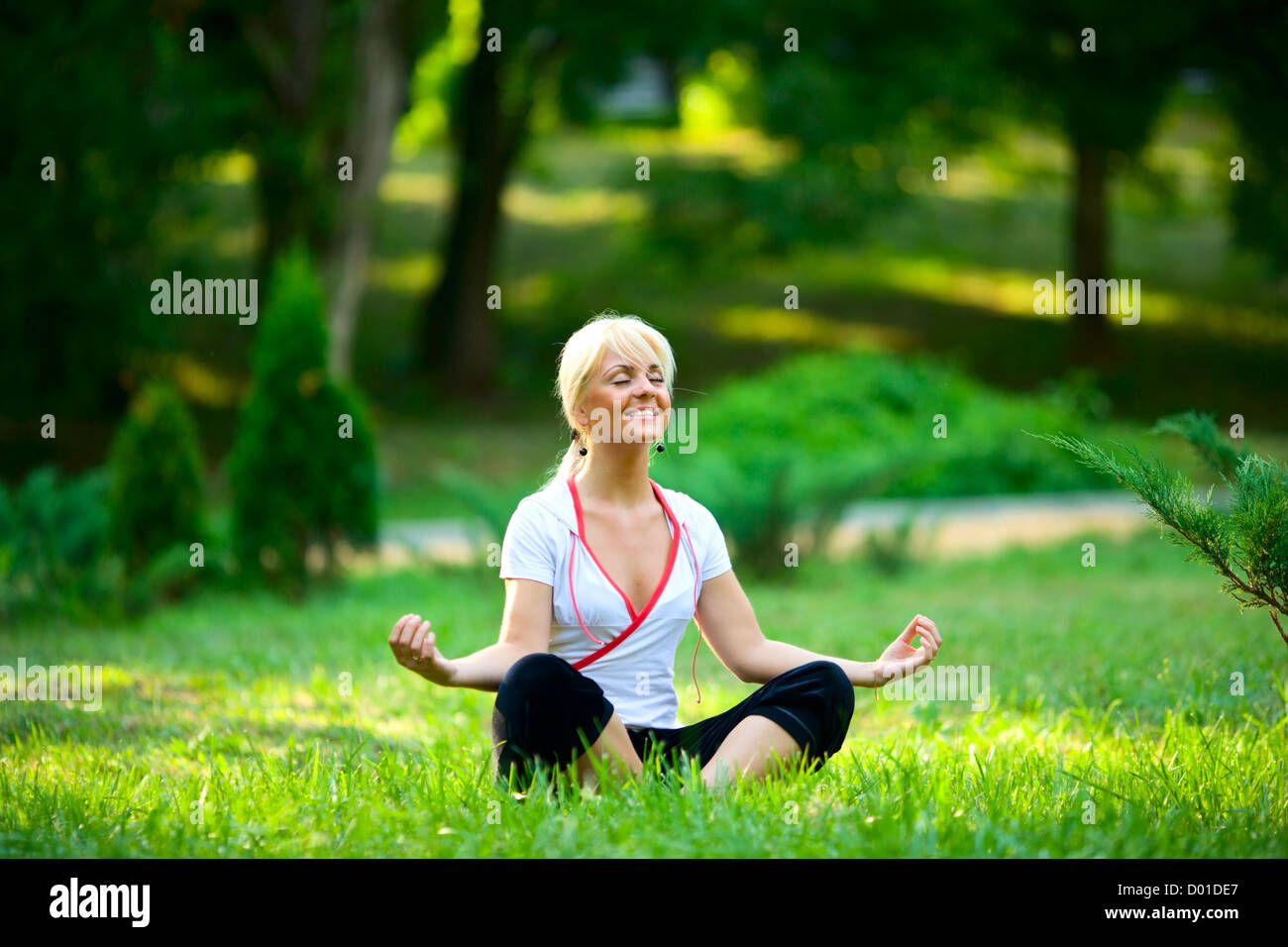 Young woman relax after exercising in summer park Stock Photo - Alamy