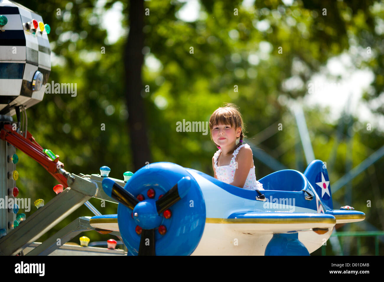 Happy little girl riding carousel in toy airplane Stock Photo - Alamy