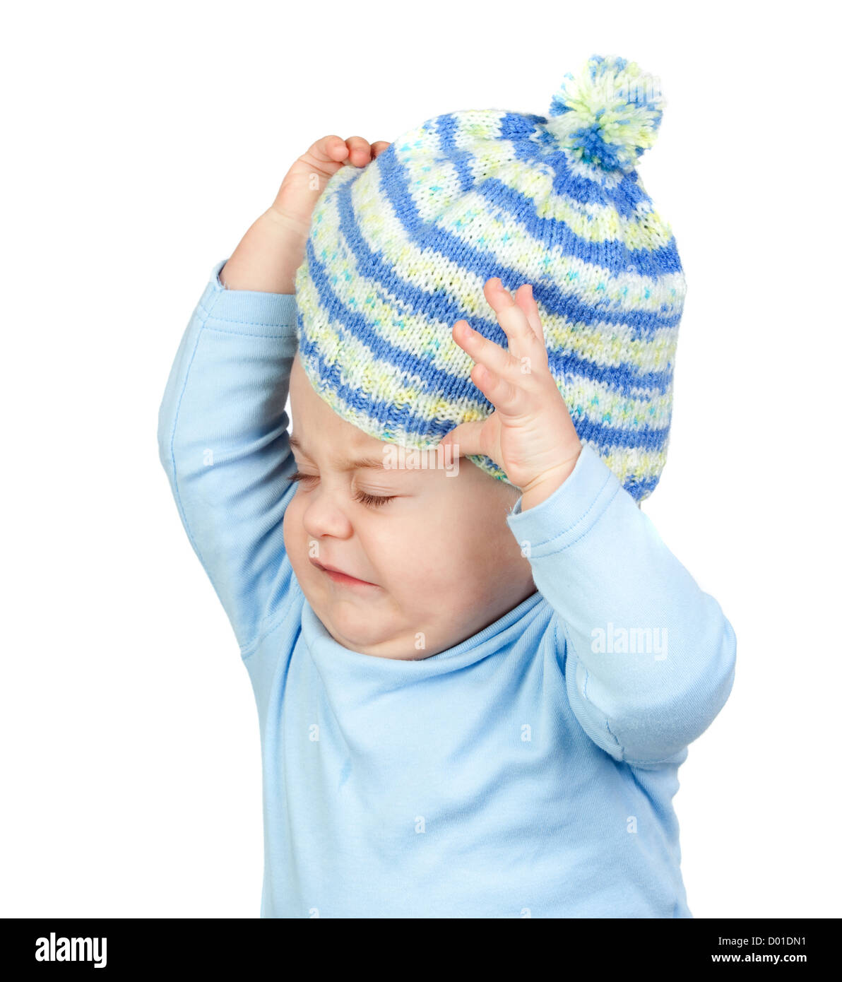 Angry baby taking off a wool cap isolated on white background Stock ...