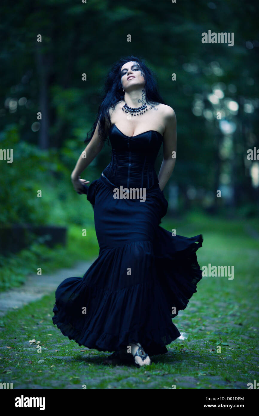 Young beautiful demonic female creature walking through the night Stock ...