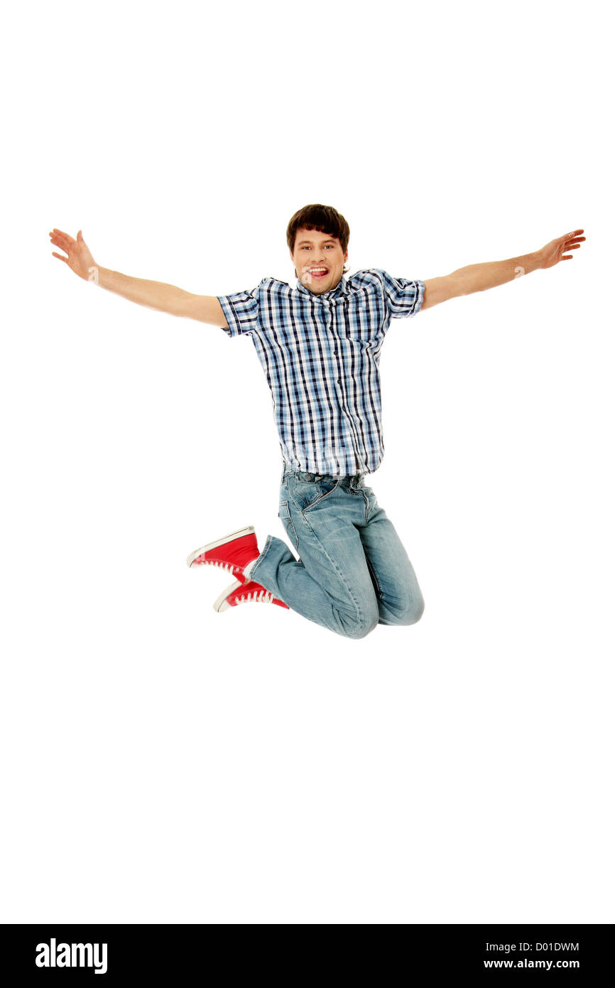 Young happy caucasian man jumping in the air Stock Photo - Alamy