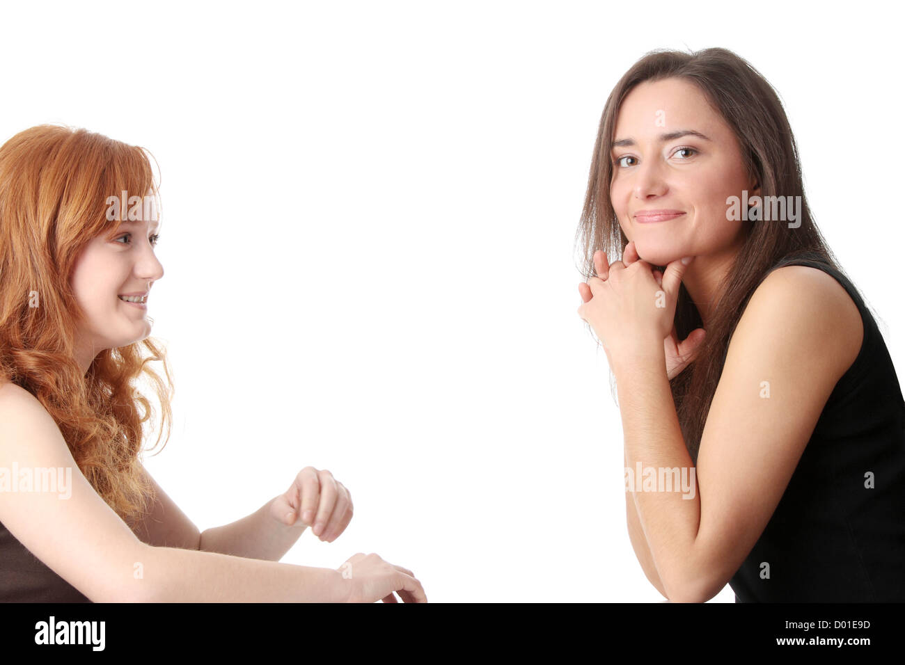 Two young womans talking isolated on white background Stock Photo - Alamy