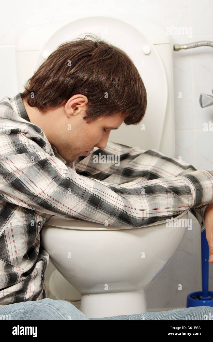 Young man (drunk or sick) vomiting Stock Photo - Alamy