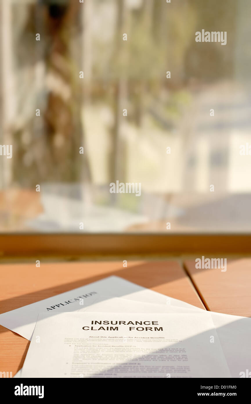 Insurance claim form on desk near windows Stock Photo - Alamy