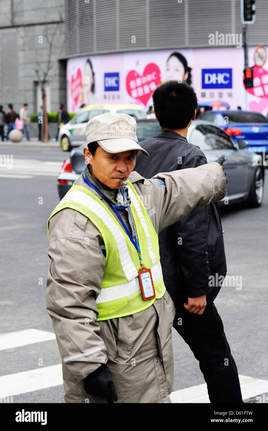 Directing traffic in Shanghai Stock Photo - Alamy