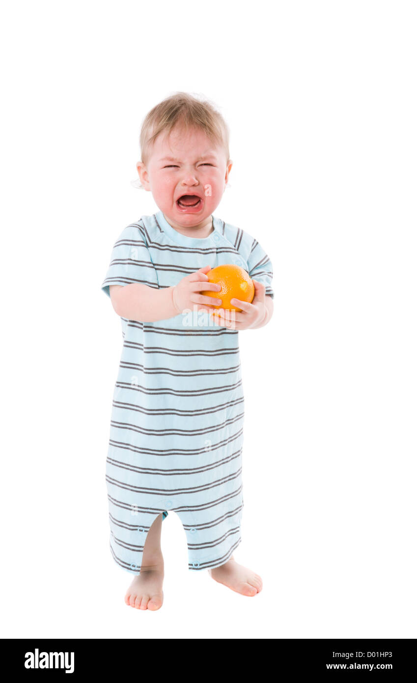 Crying baby holding orange isolated on white Stock Photo - Alamy