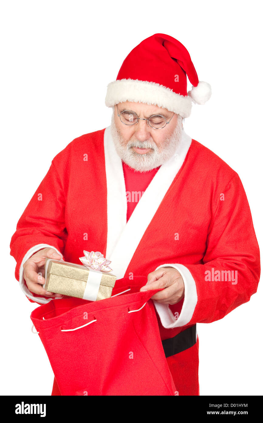 Santa Claus getting a gift from his sack isolated on white background ...