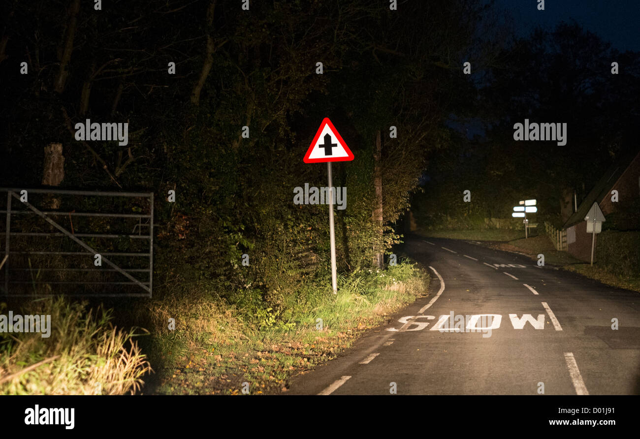 At a crossroads. Driving at night along country lanes negotiating ...
