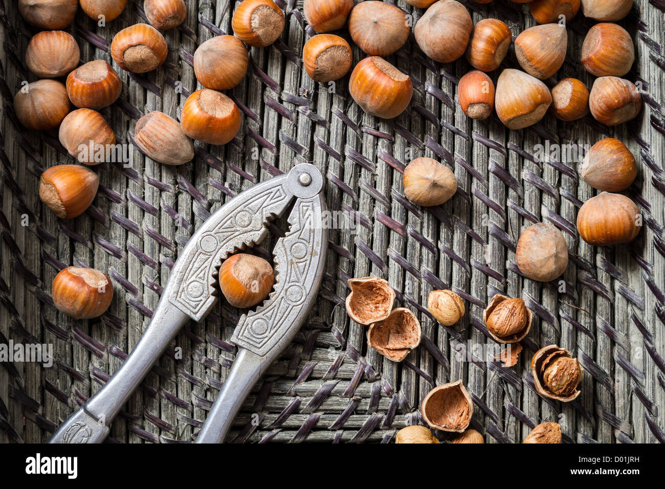 Closeup hazelnuts with nutcracker and nutshells in old basket Stock ...