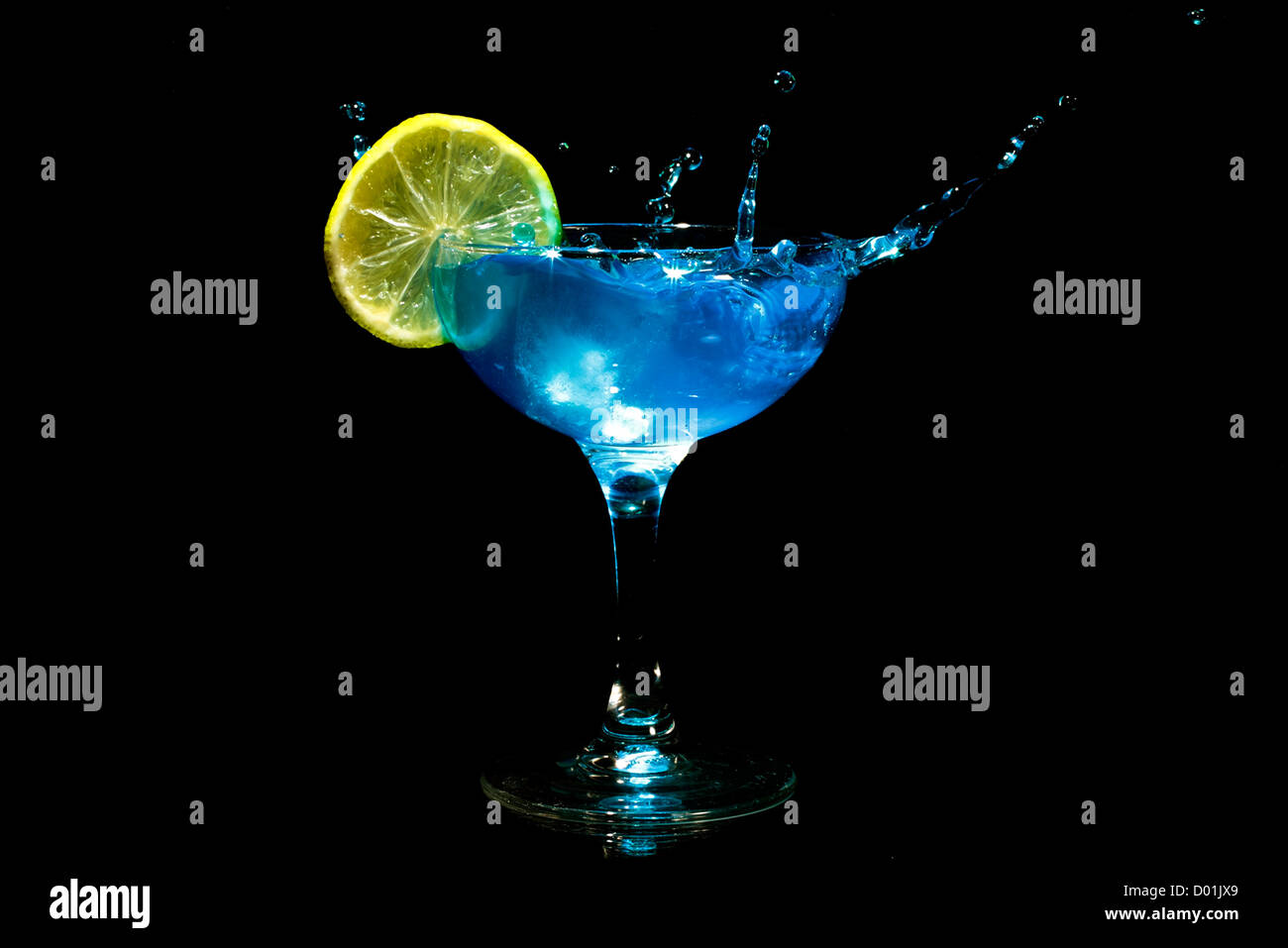 Blue cocktail splash with citron Stock Photo - Alamy