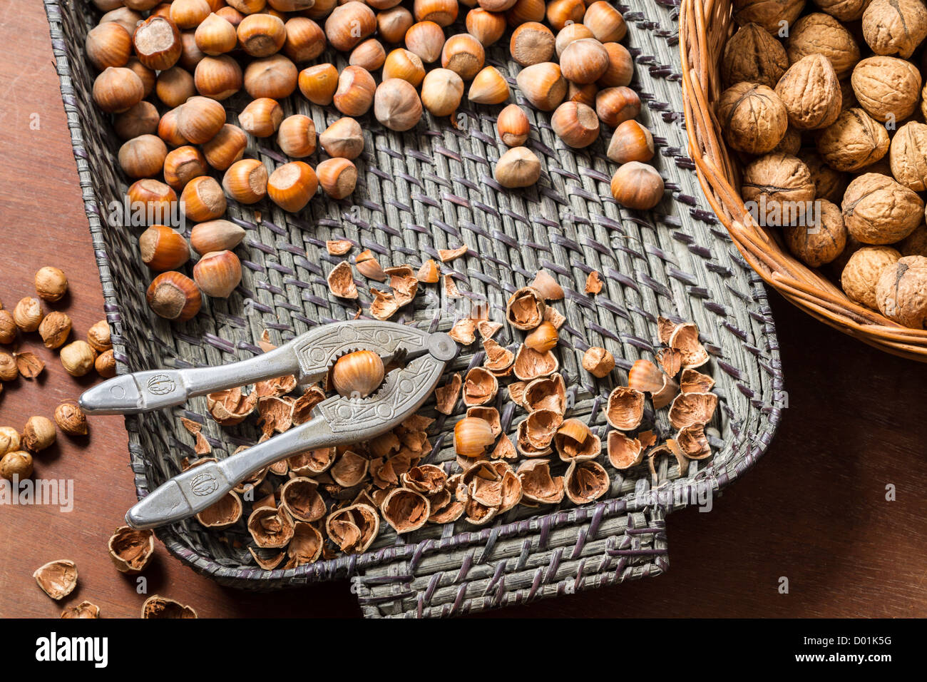 Cracking nuts hazelnuts in wicker basket Stock Photo - Alamy